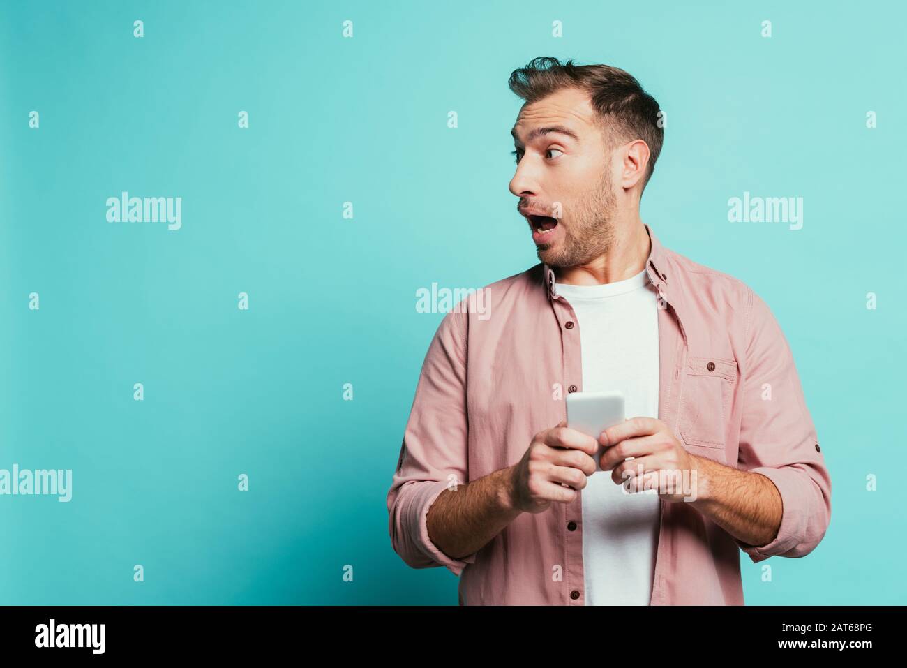 Shocked handsome man using hi-res stock photography and images - Alamy