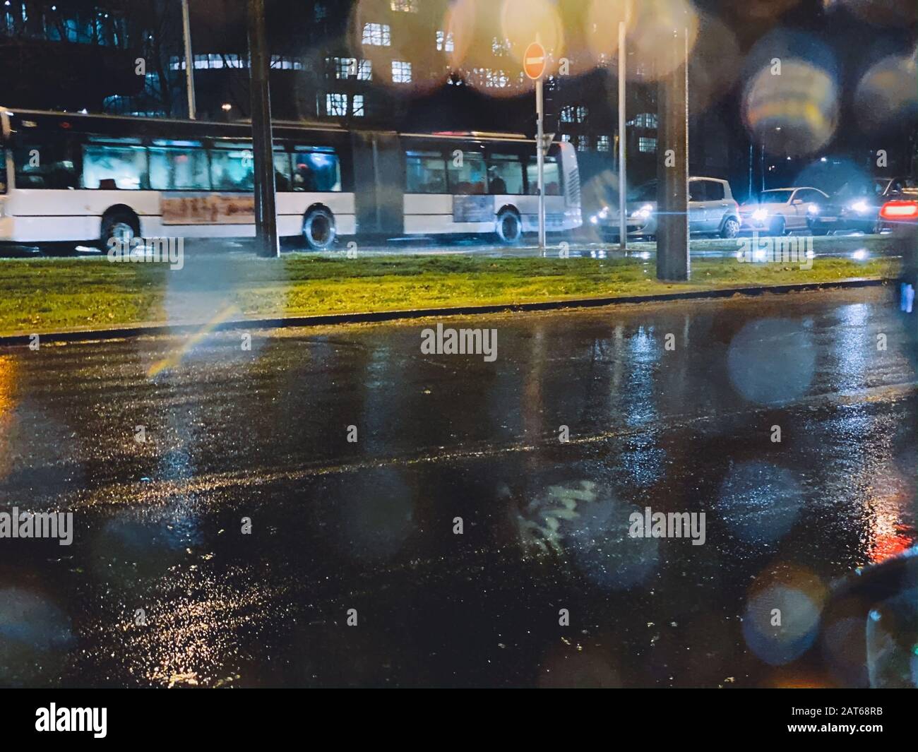 View of busy city night scene street with public bus transportation and ...