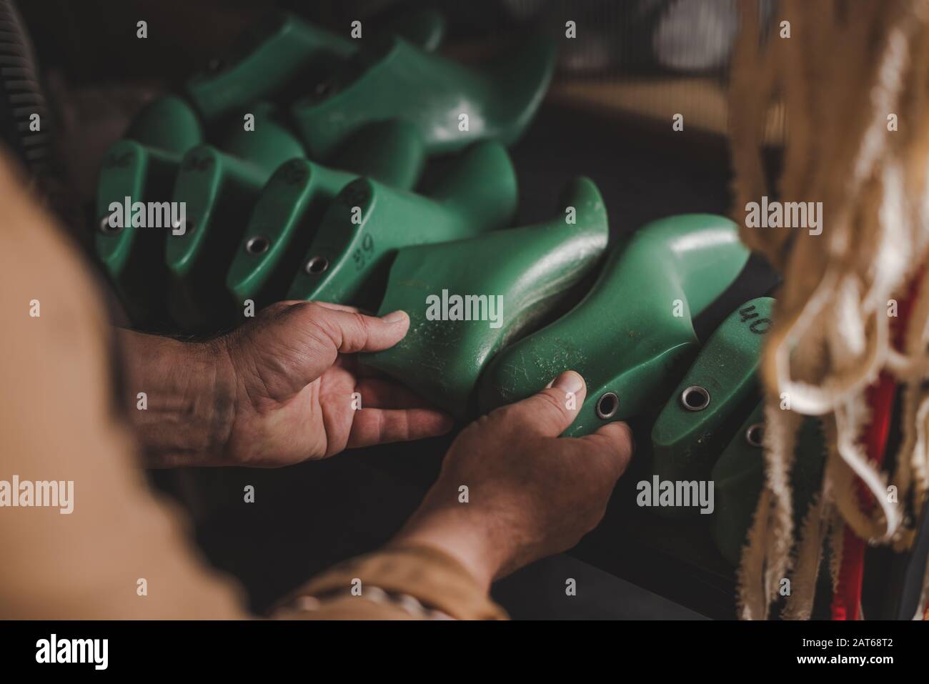 cropped view of shoemaker holding shoe last in workshop Stock Photo - Alamy