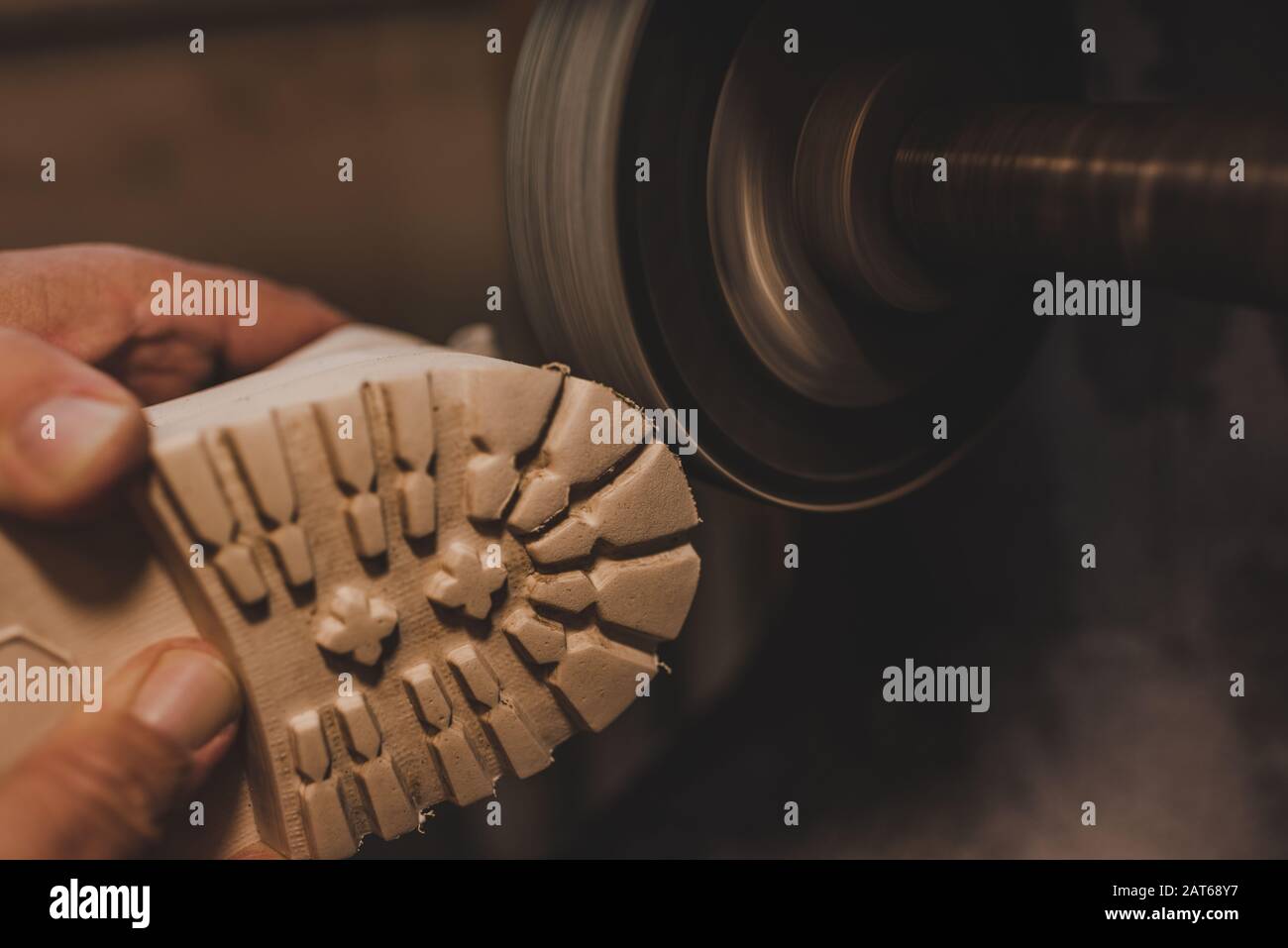 cropped view of cobbler polishing shoe sole on grinding machine Stock ...