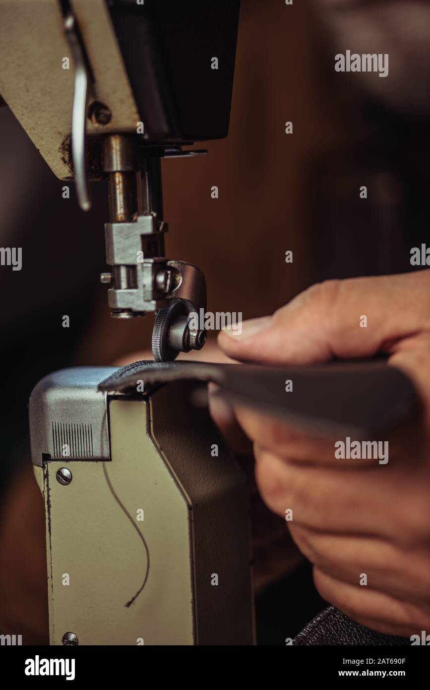 cropped view of cobbler sewing genuine leather on sewing machine Stock ...
