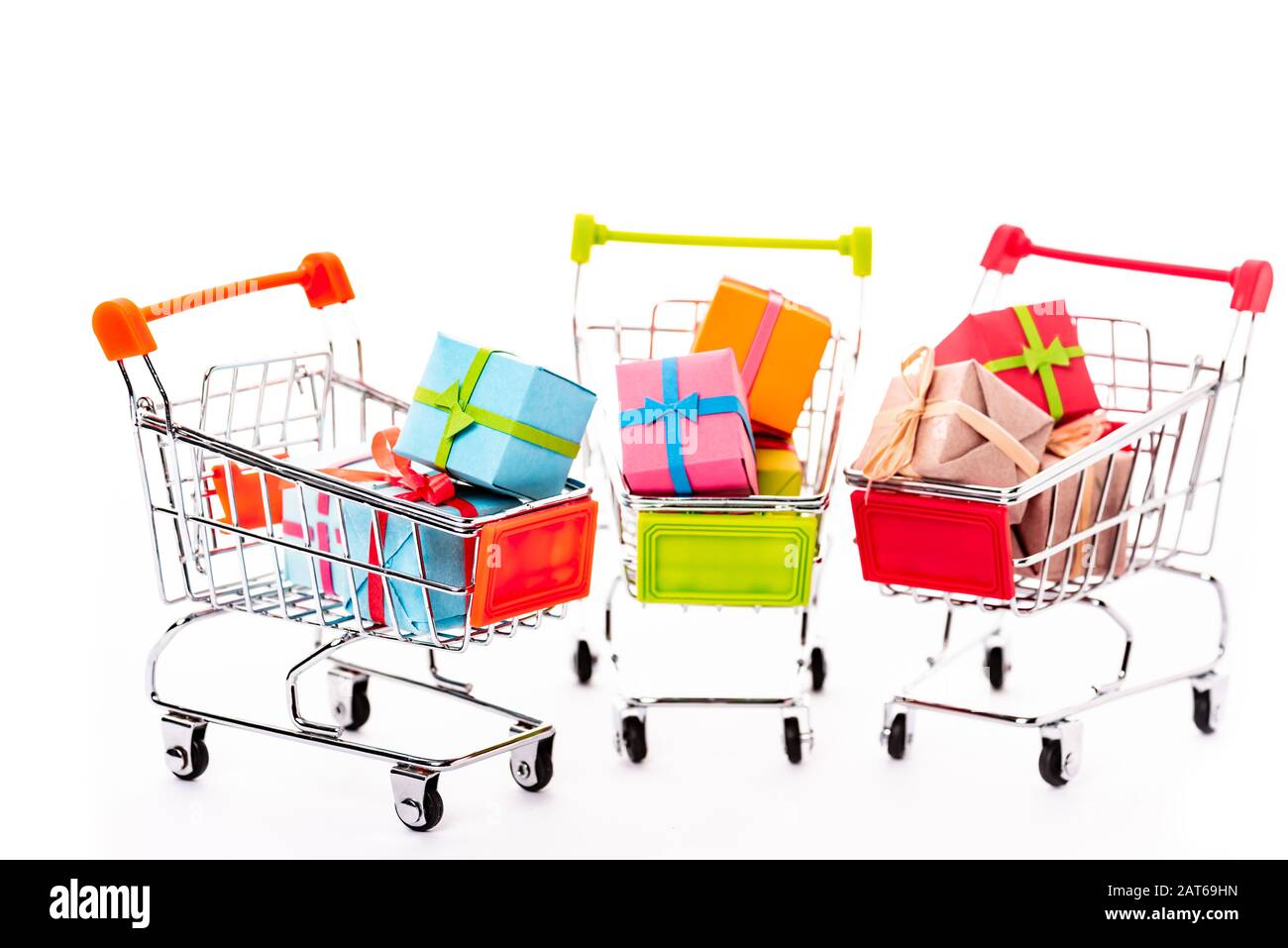 decorative small shopping carts with gift boxes isolated on white Stock ...