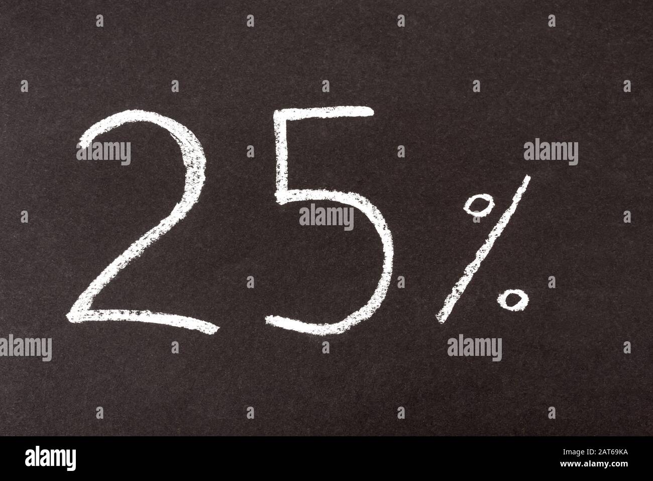 top view of number 25 and percent sign written on black chalkboard ...
