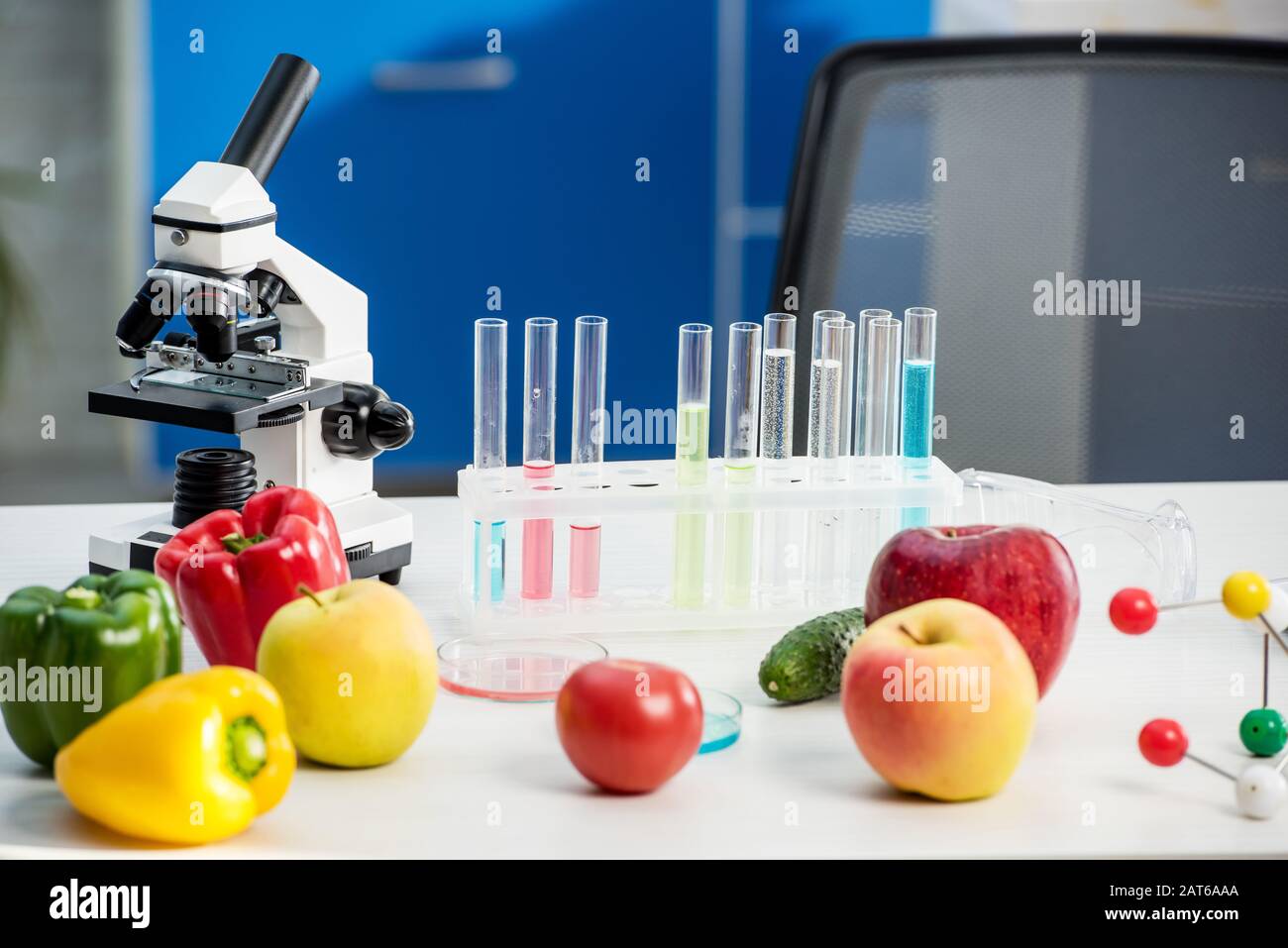 microscope, fruit, vegetables, test tubes on table in lab Stock Photo ...