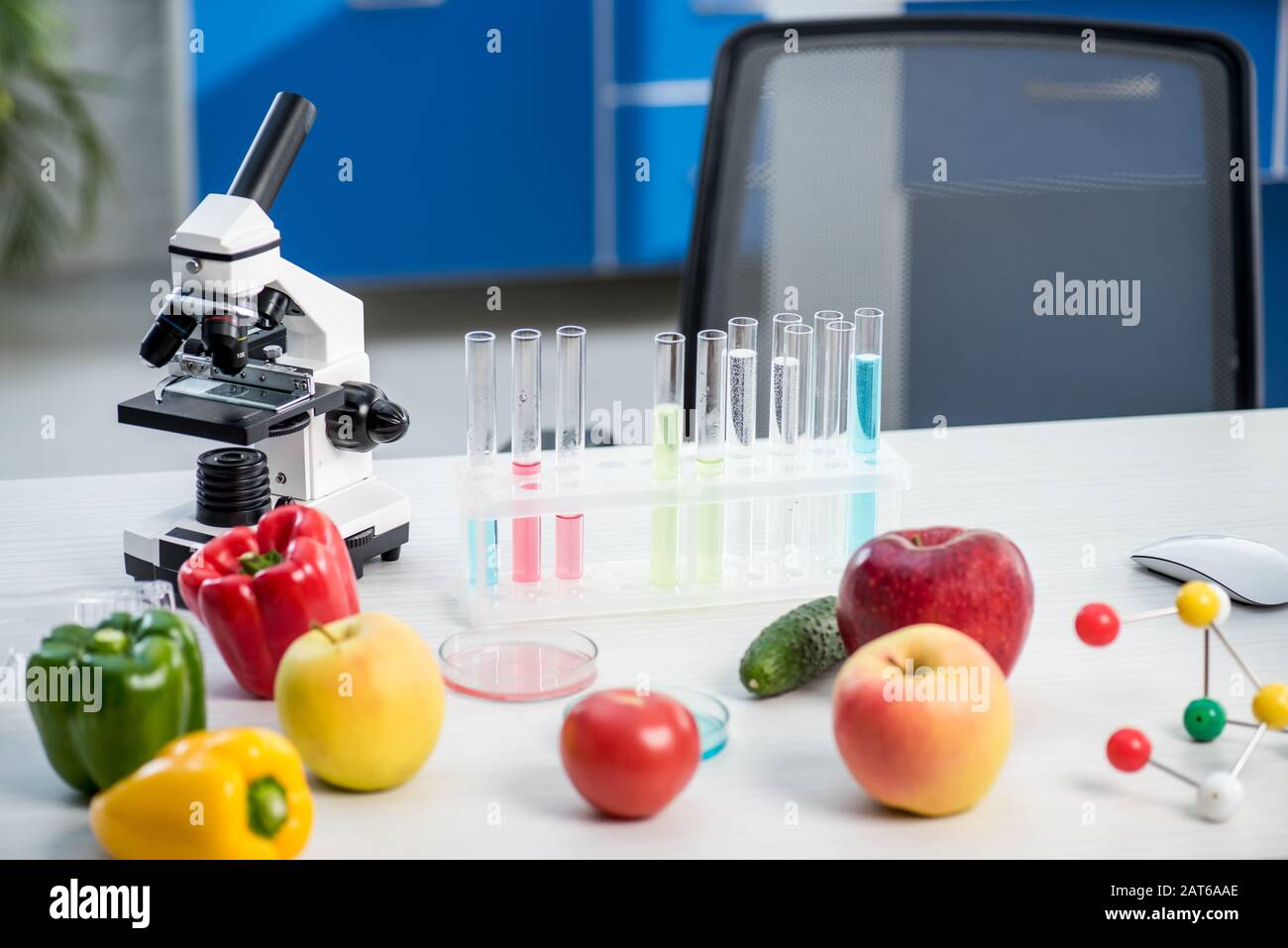 microscope, fruit, vegetables, test tubes on table in lab Stock Photo ...
