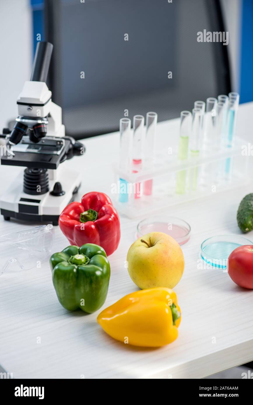 microscope, fruit, vegetables, test tubes on table in lab Stock Photo ...