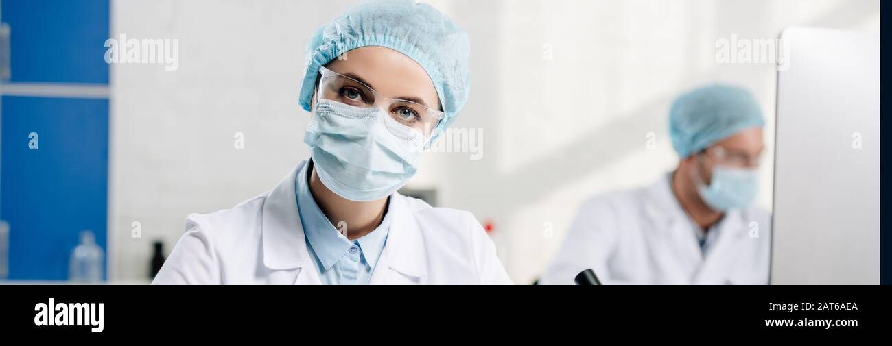 panoramic shot of genetic consultant looking at camera in lab Stock ...