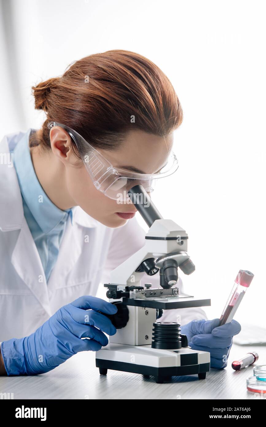 genetic consultant in white coat using microscope in lab Stock Photo ...