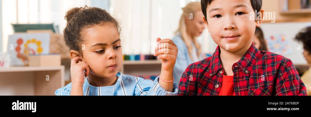 Panoramic shot of kids during lesson with teacher and children at ...