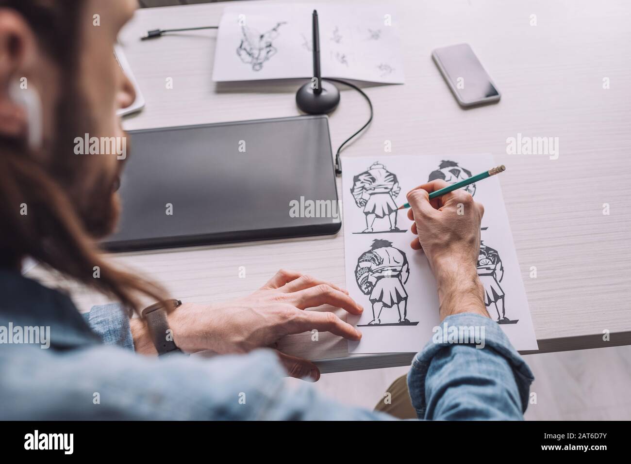 selective focus of illustrator drawing cartoon sketches Stock Photo - Alamy