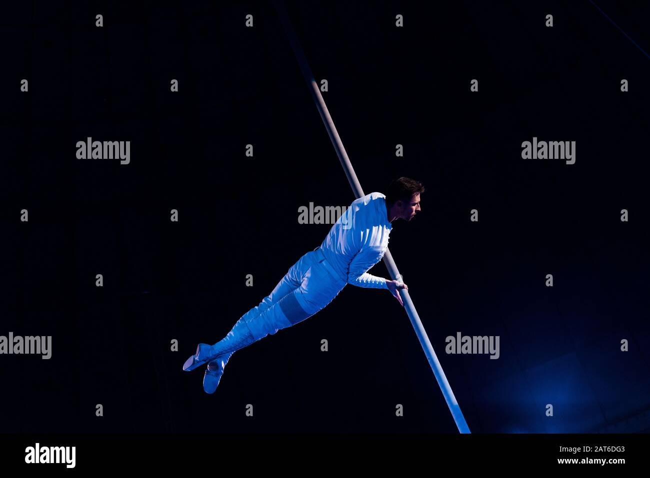 handsome acrobat balancing in arena of circus Stock Photo - Alamy