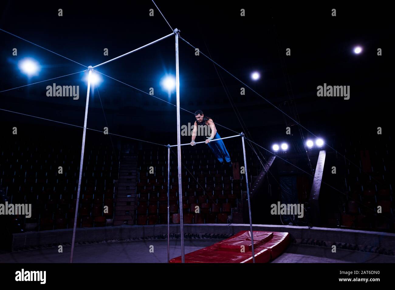 handsome gymnast performing on horizontal bars in circus Stock Photo ...
