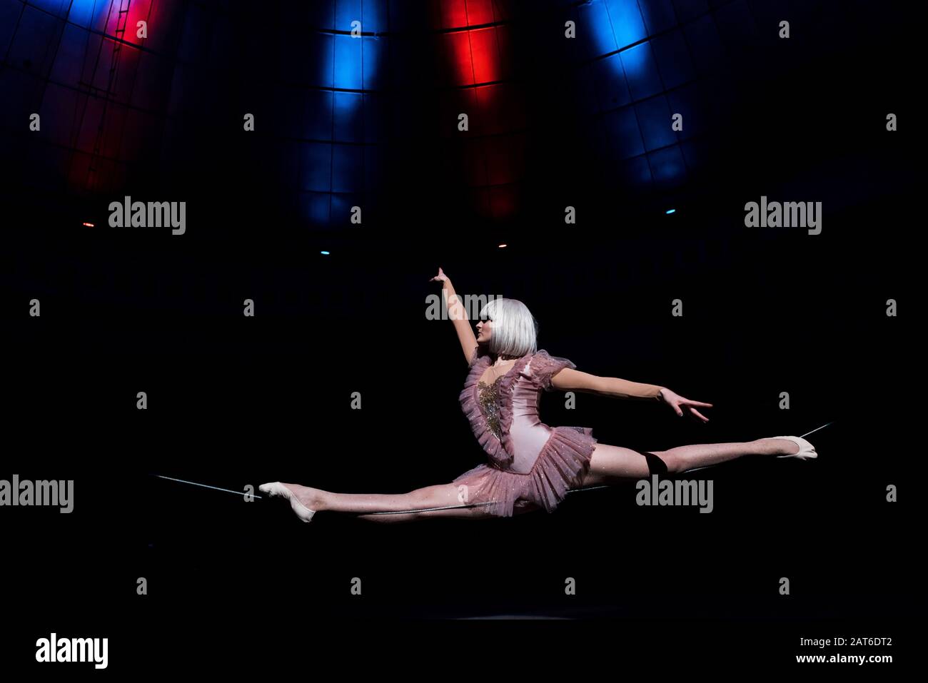 side view of beautiful aerial acrobat doing splits on rope Stock Photo ...