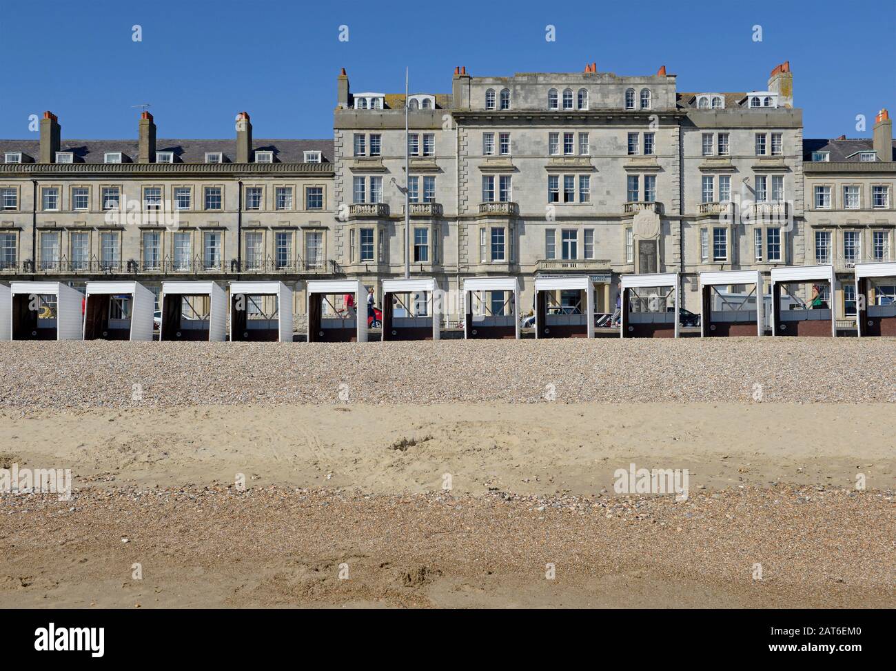 Victorian era houses by the seafront with bathhouses in front on the ...