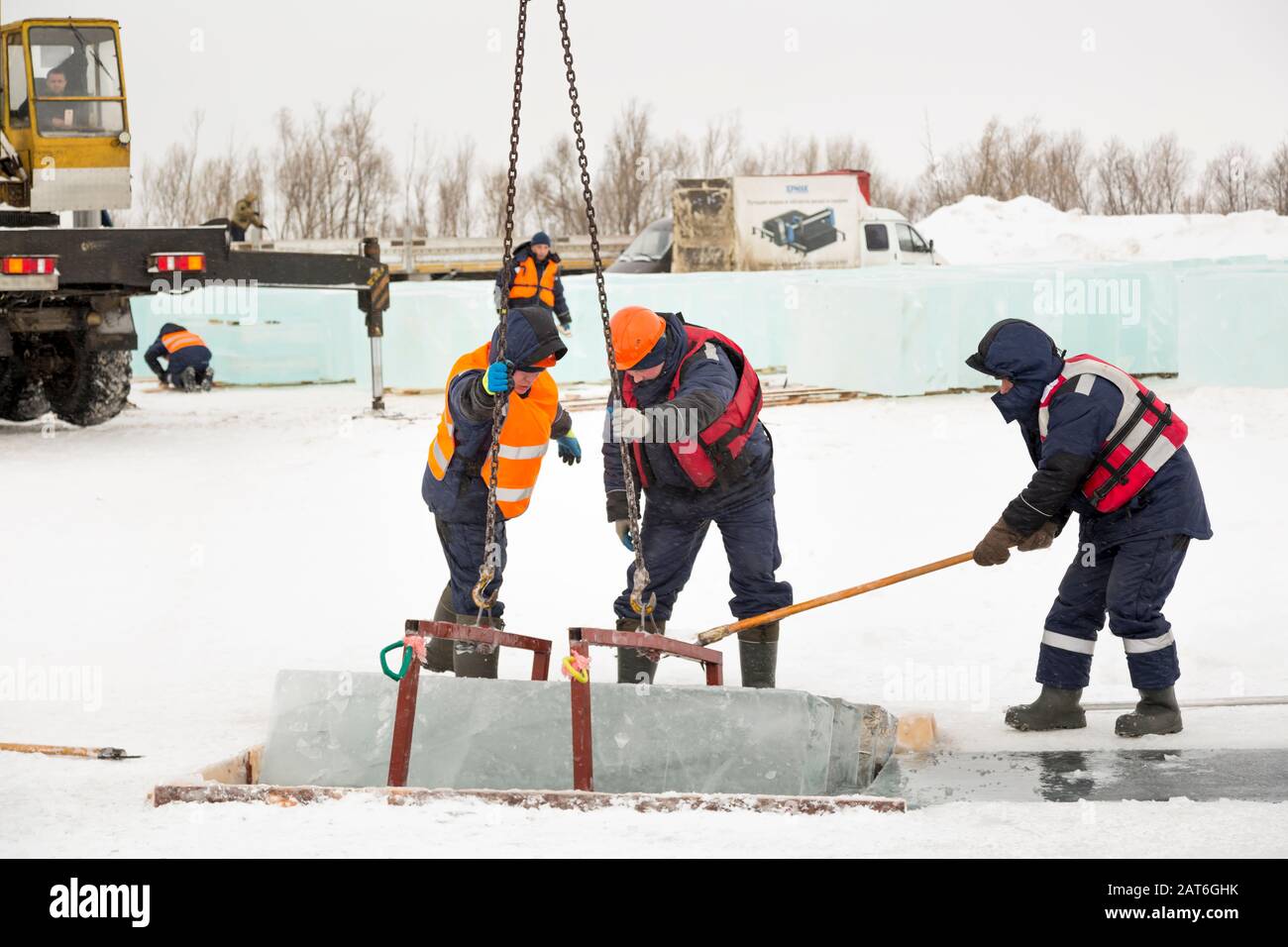 Workers catch ice blocks in the lane Stock Photo - Alamy