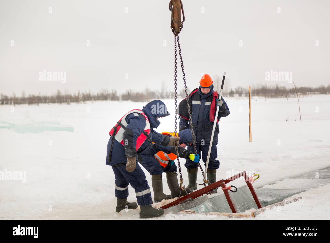 Workers catch ice blocks in the lane Stock Photo - Alamy