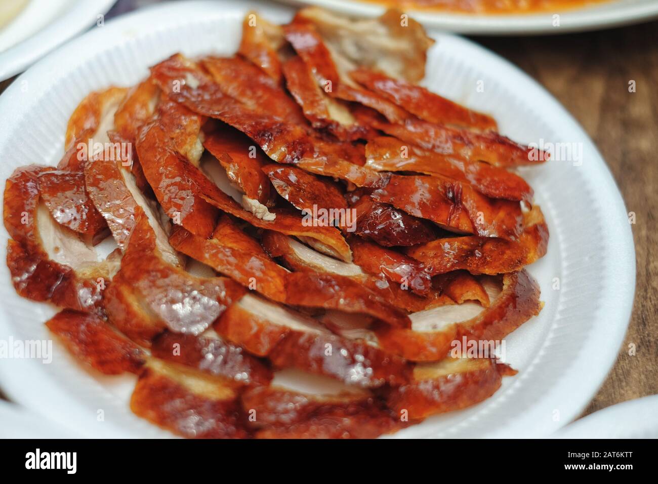Sliced Peking duck on a white paper plate at Singapore street food ...