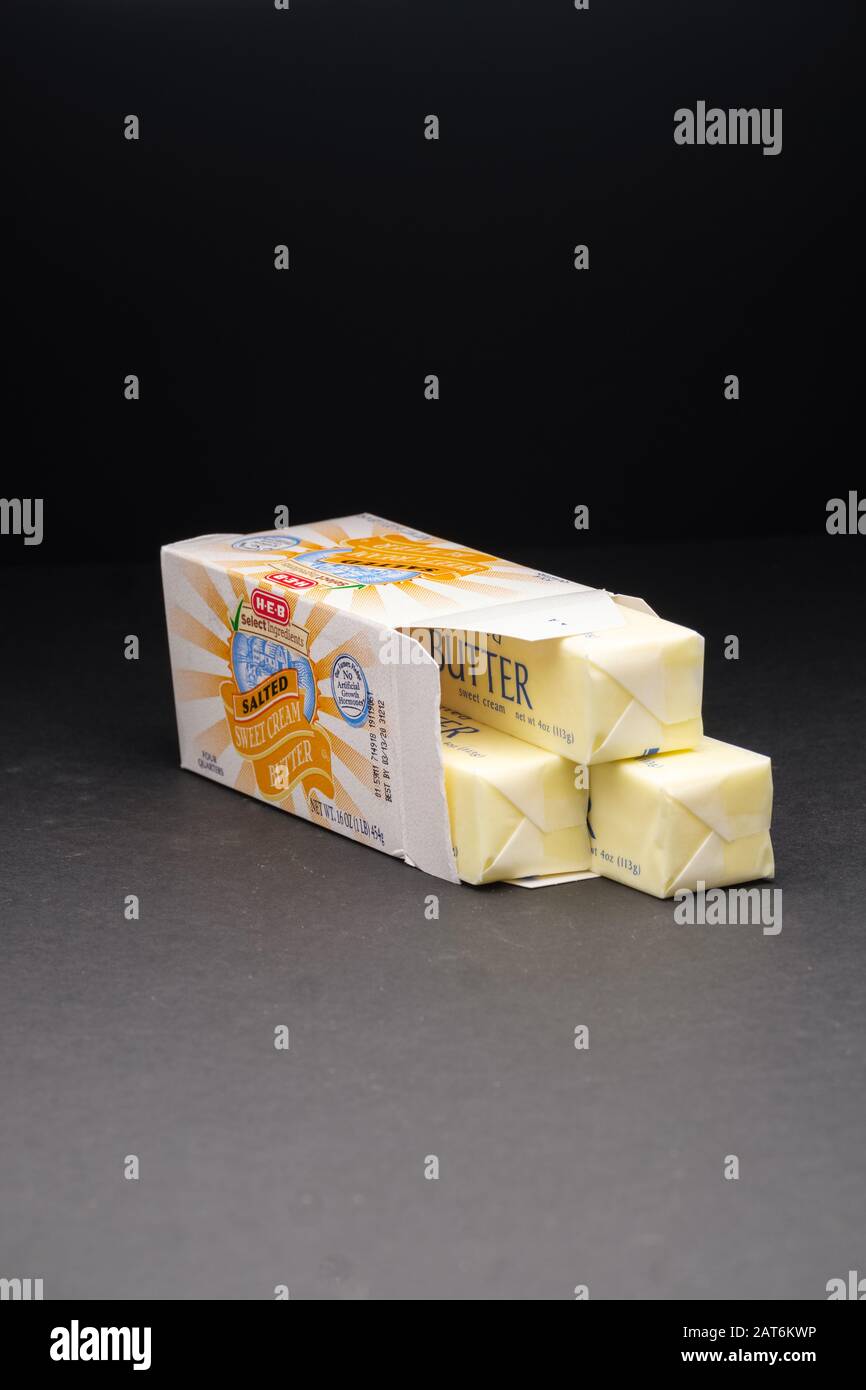 Sticks of yellow butter in open box on dark background Stock Photo - Alamy