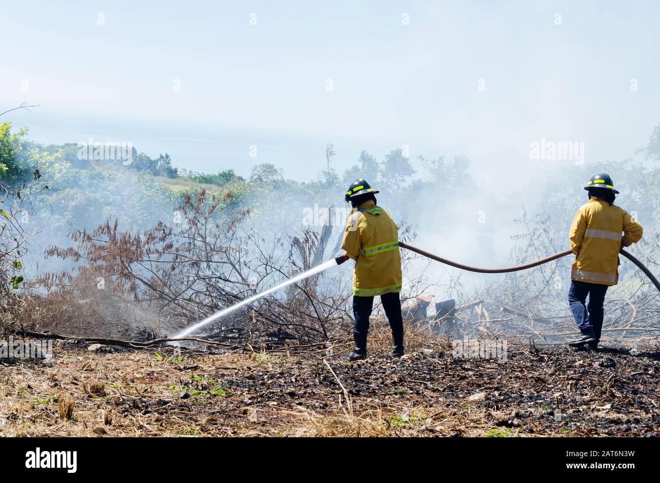 Fireman holding water hose hi-res stock photography and images - Alamy