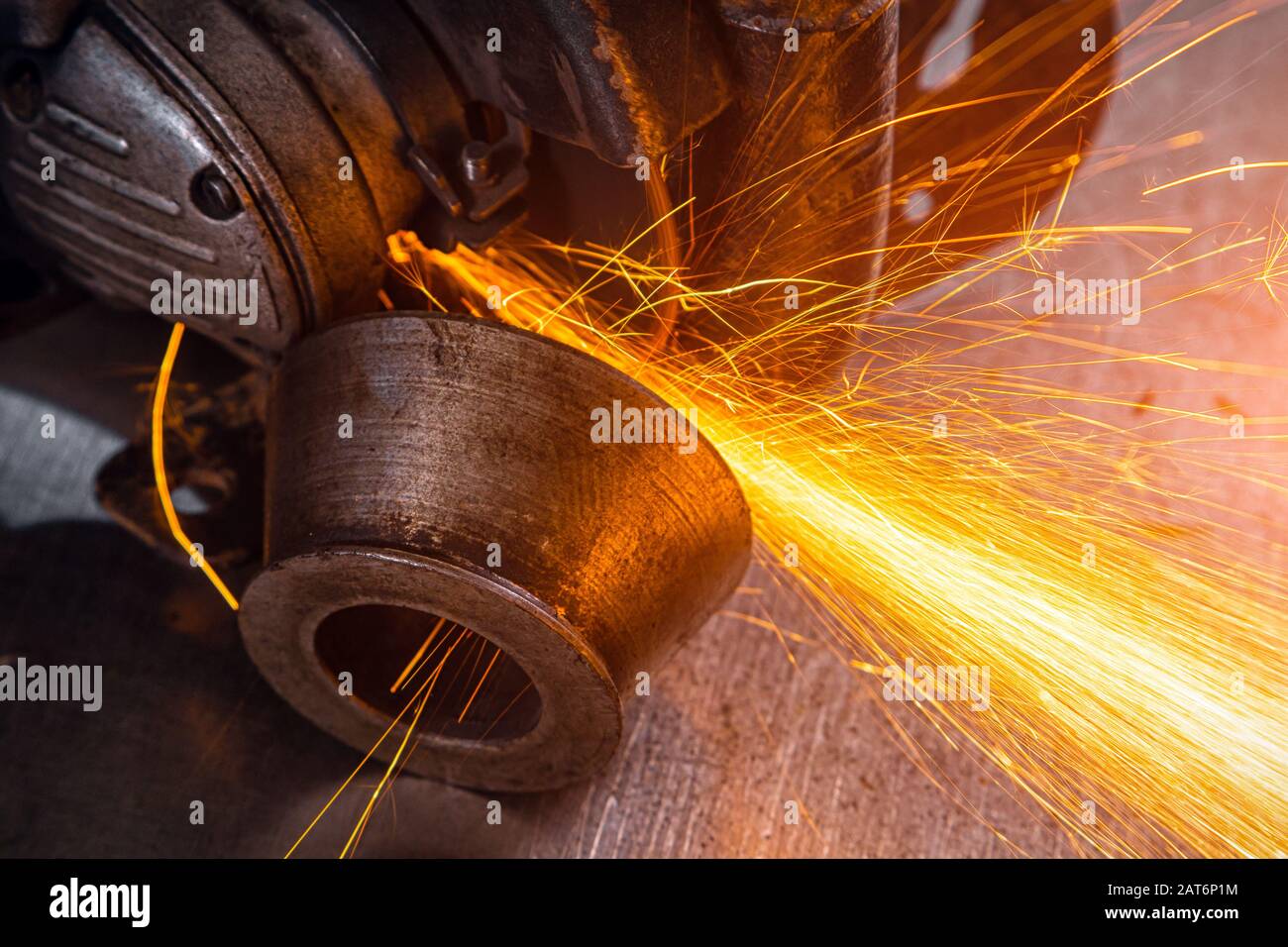 Sparks fire closeup on a black background. Material joining production ...