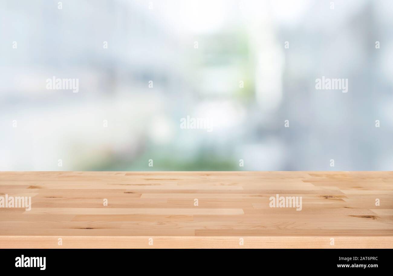 Selective focus of wood table top on white wall glass (big window ...