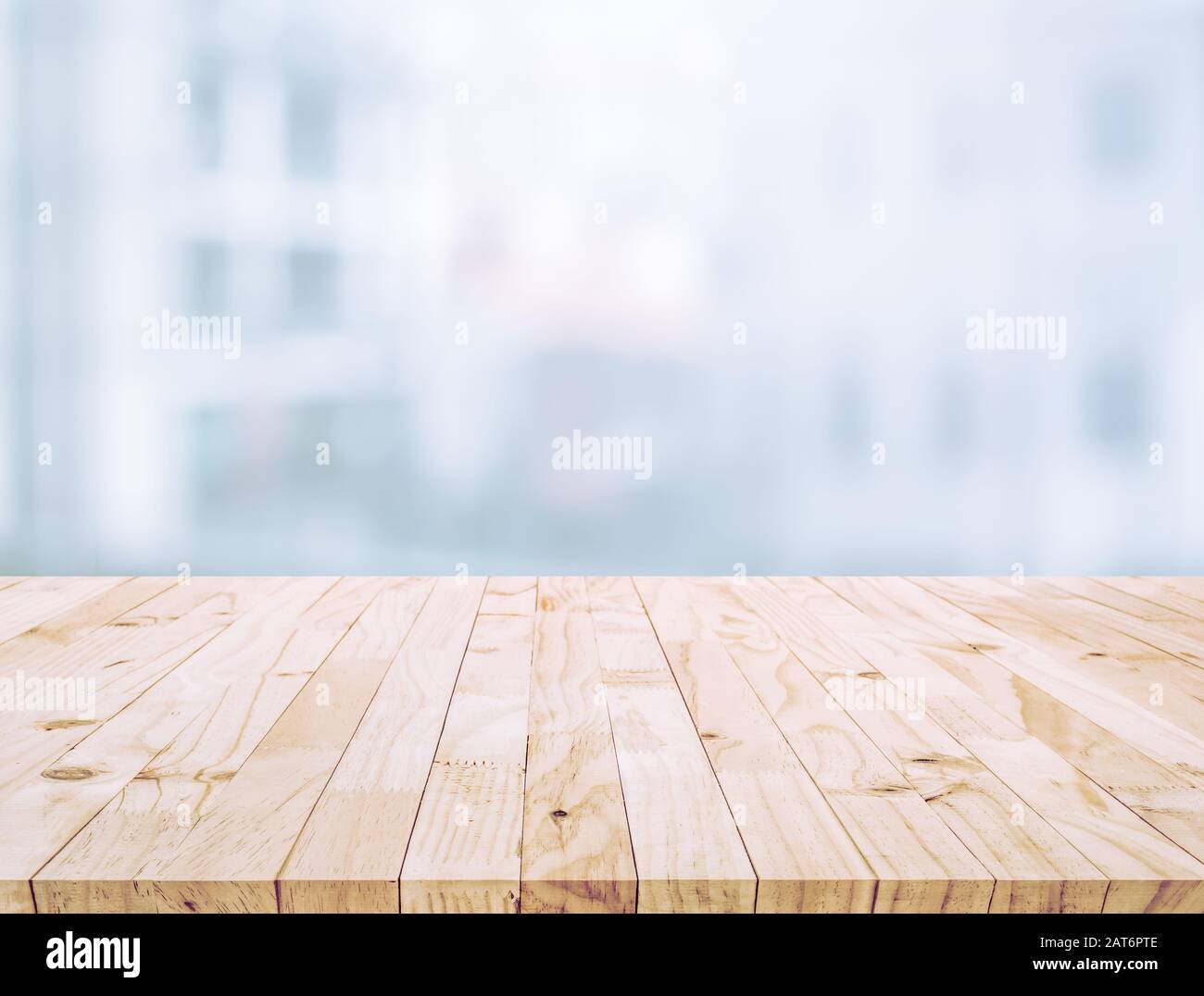 Selective focus of wood table top on white wall glass (big window ...
