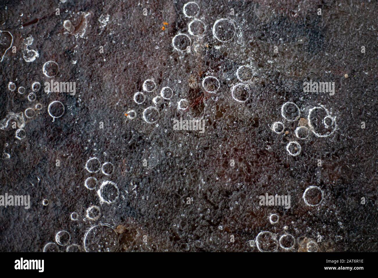 Bubbles of air in frozen water. The texture of the ice in nature ...