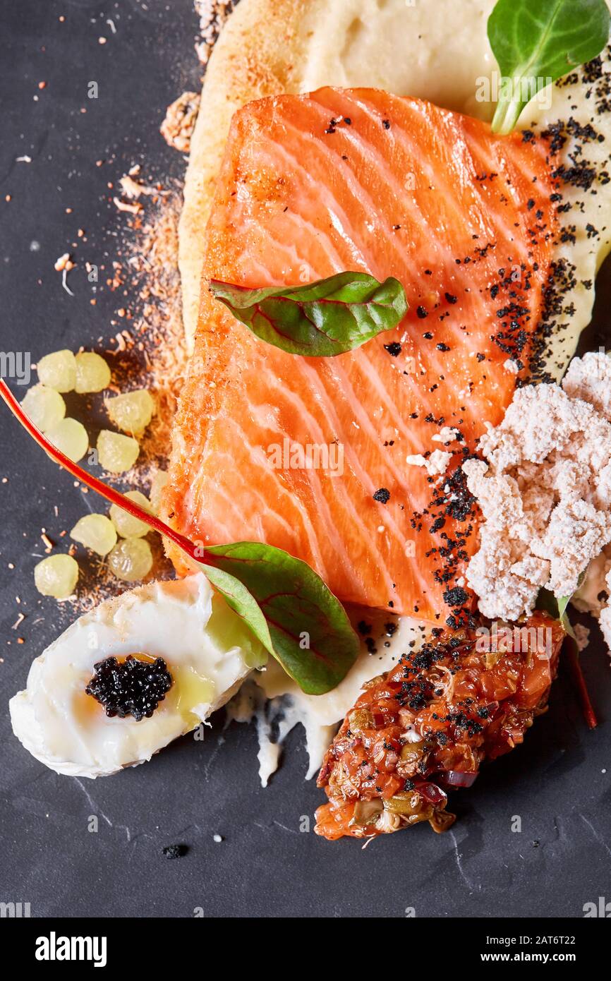 Closeup Salmon steak fillet with eggs and vegetables. Restaurant menu ...