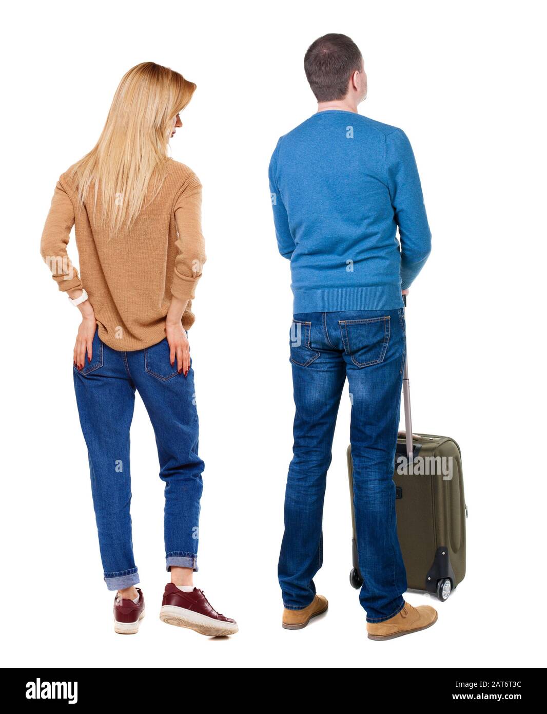 young couple in sweater traveling with suitcas. Back view. Rear view ...