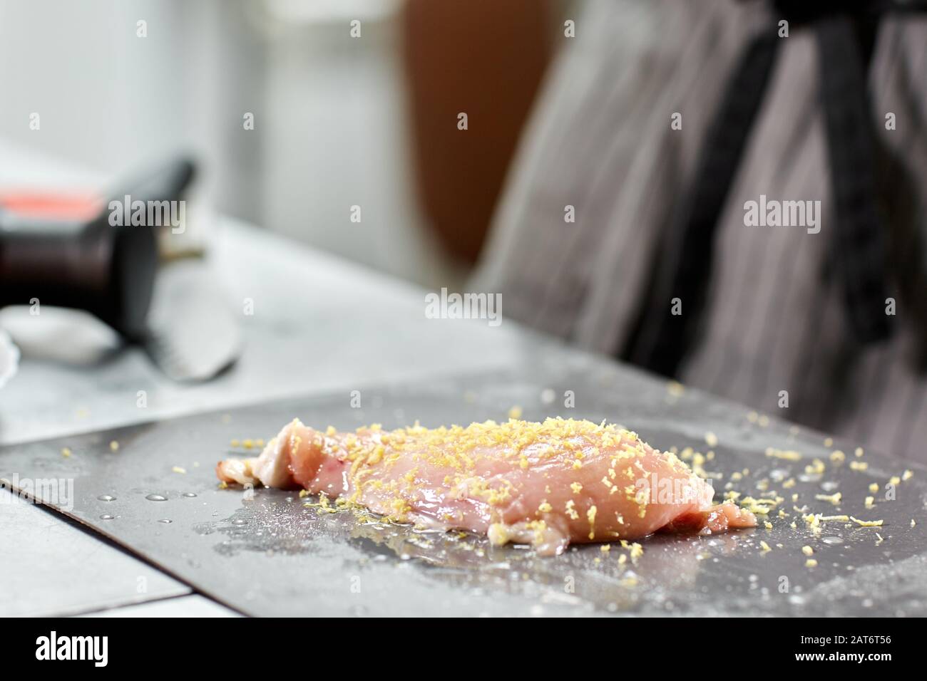 Chief chops and marinates chicken. Professional chef in a kitchen of ...