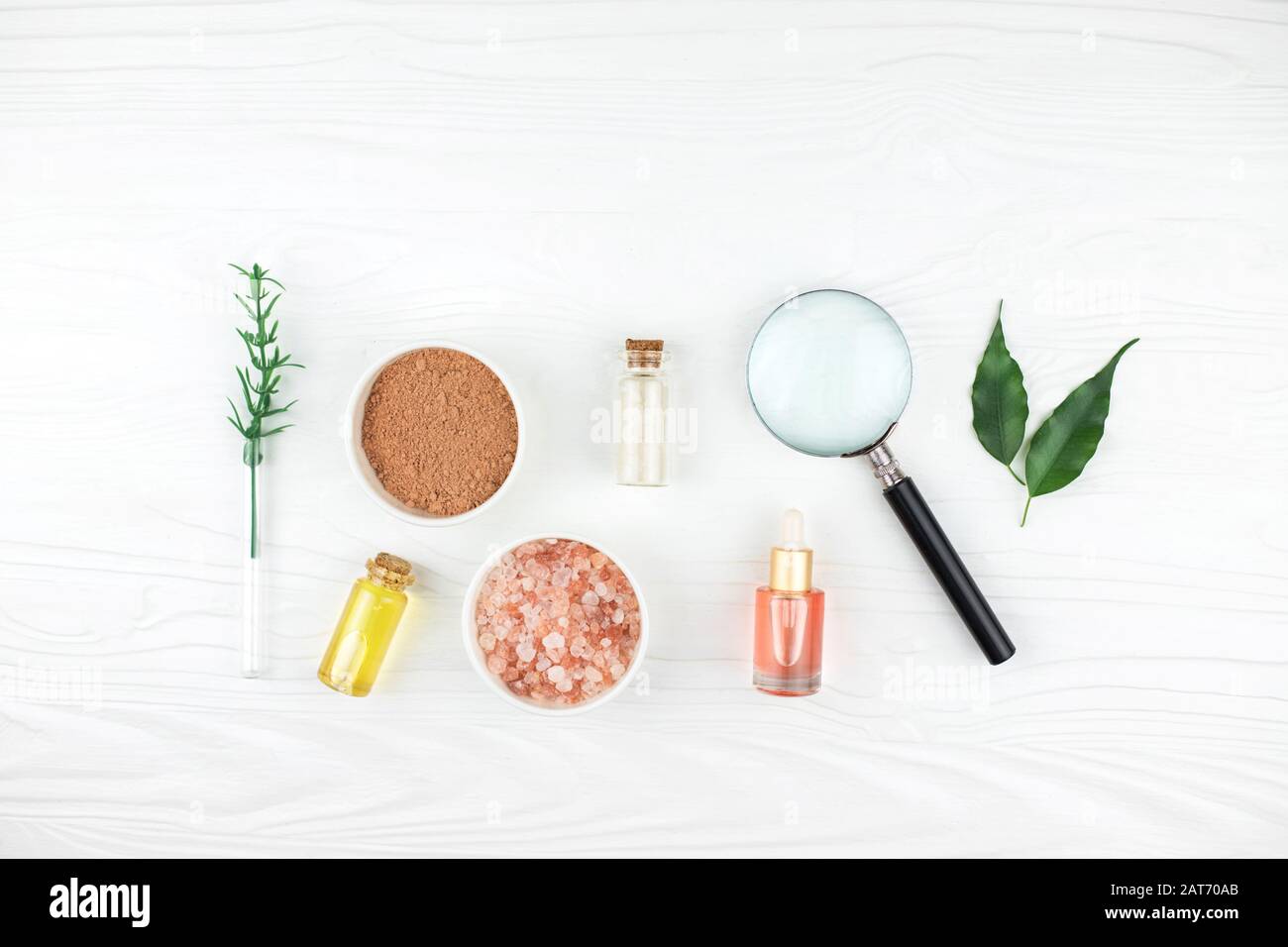 Homemade spa cosmetic set with salt and oil on white wooden background ...