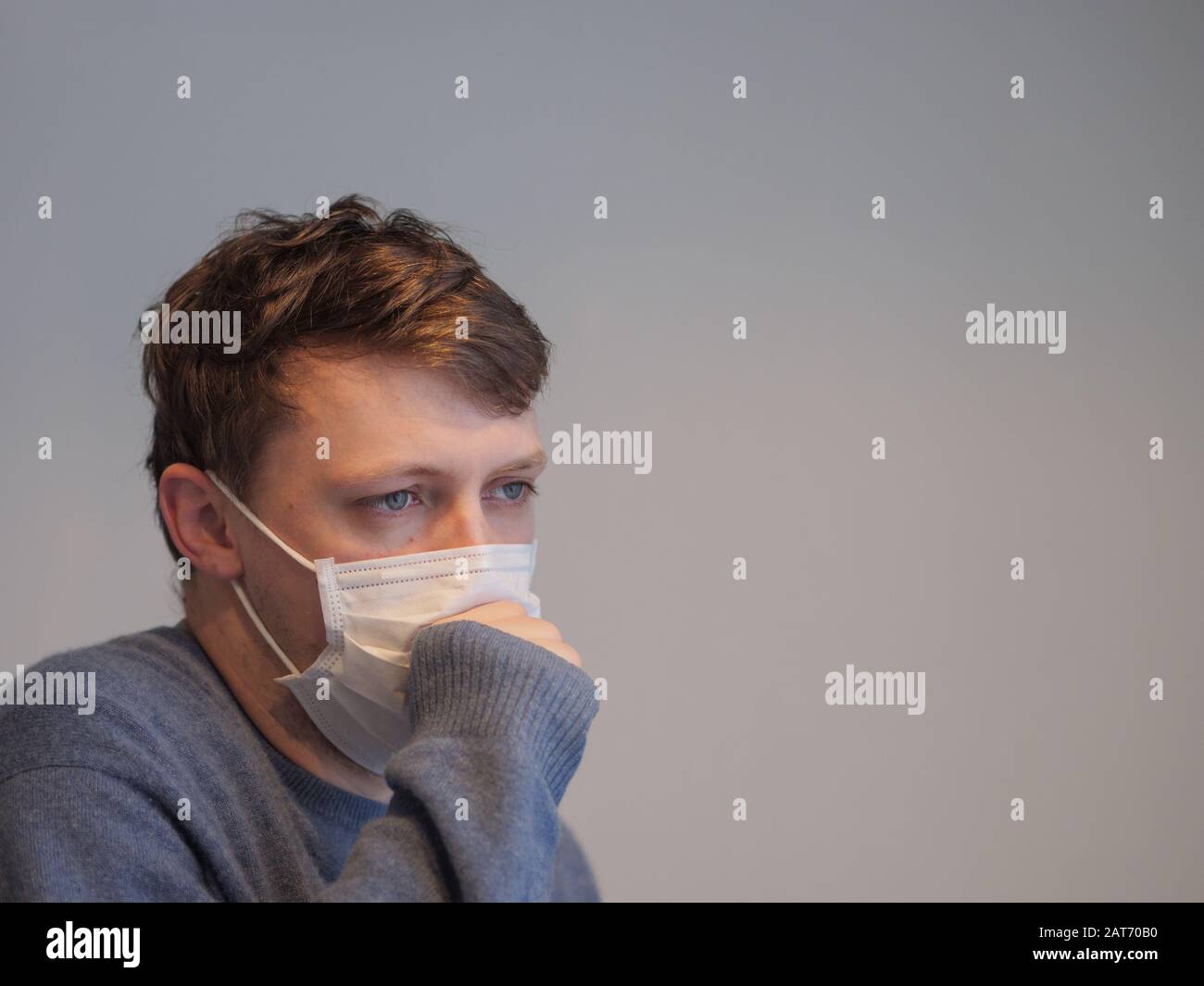 Sick man coughing in a surgical mask Stock Photo - Alamy