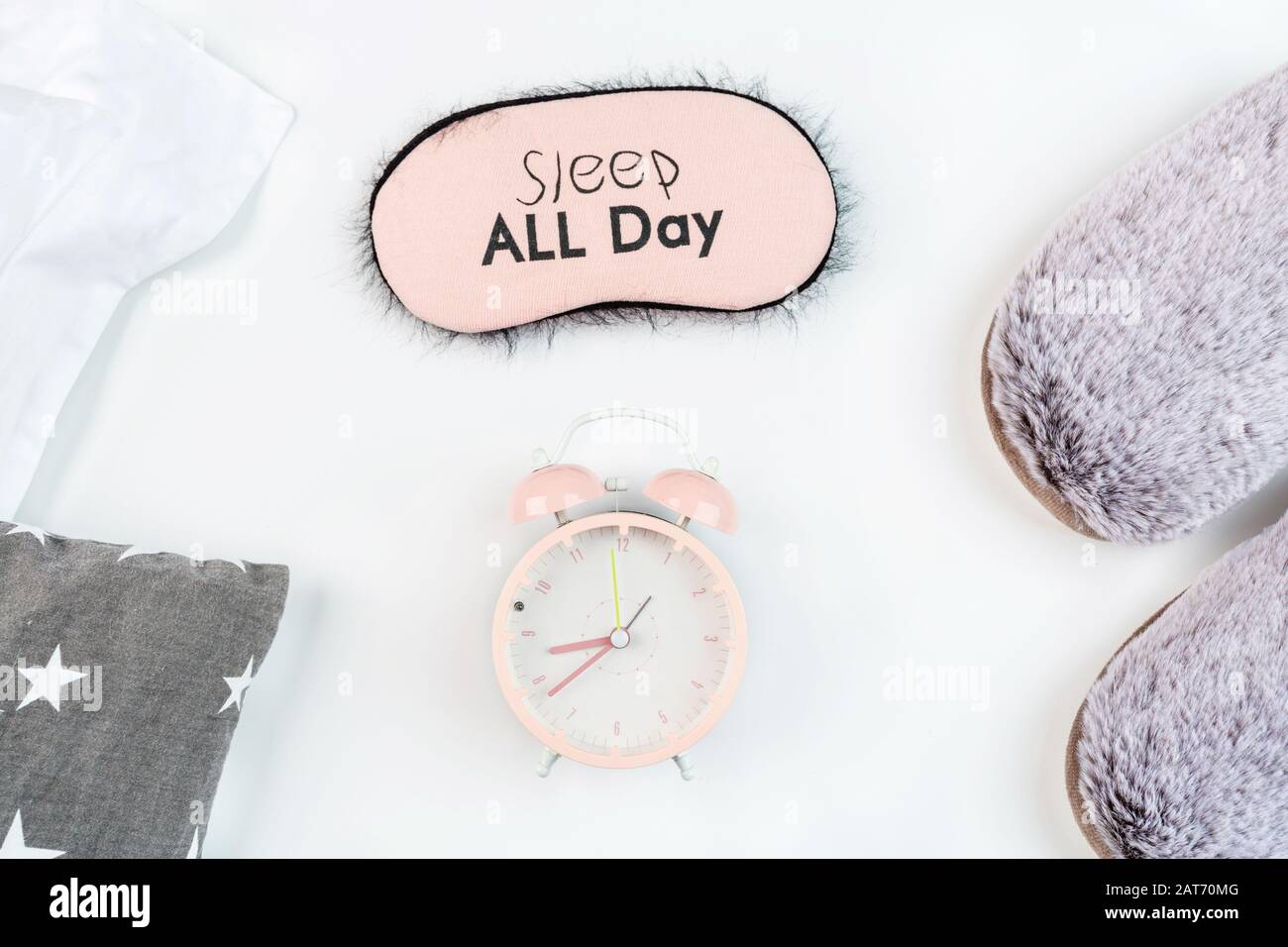 Flat lay with Soft fluffy slippers gray color, pillow, blindfold and ...