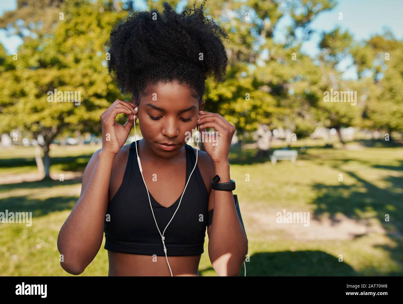 Close-up of an athletic young african american woman inserting ...