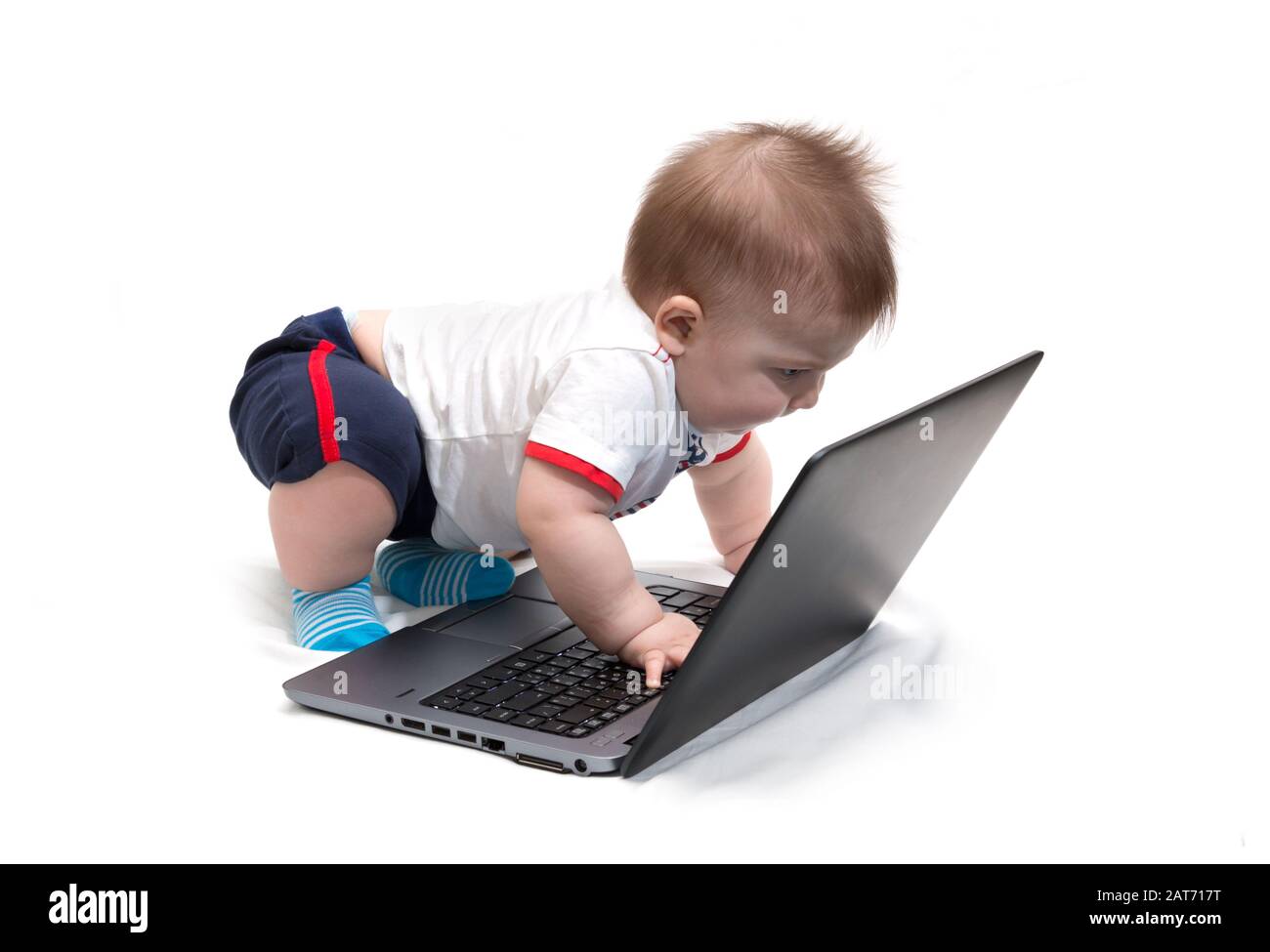 Little baby using laptop (notebook), isolated on white Stock Photo - Alamy