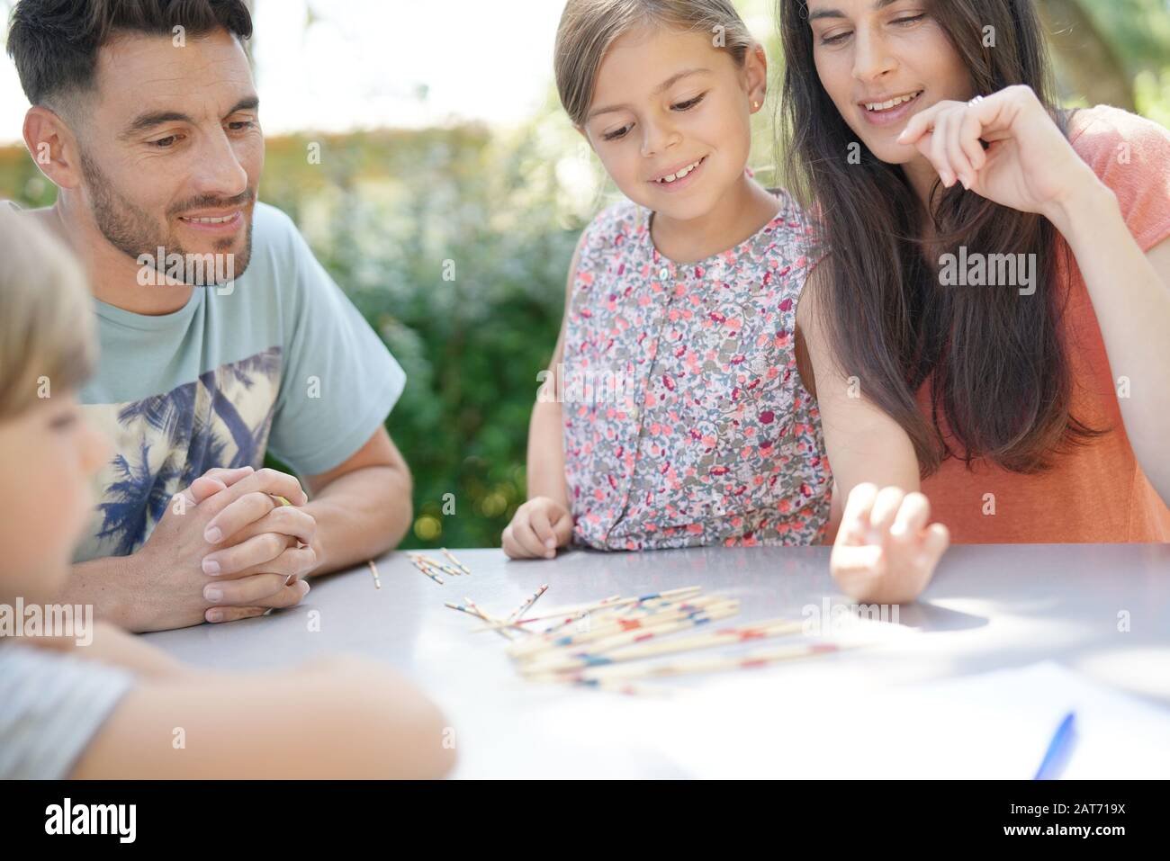 Happy family enjoying playing game together Stock Photo - Alamy