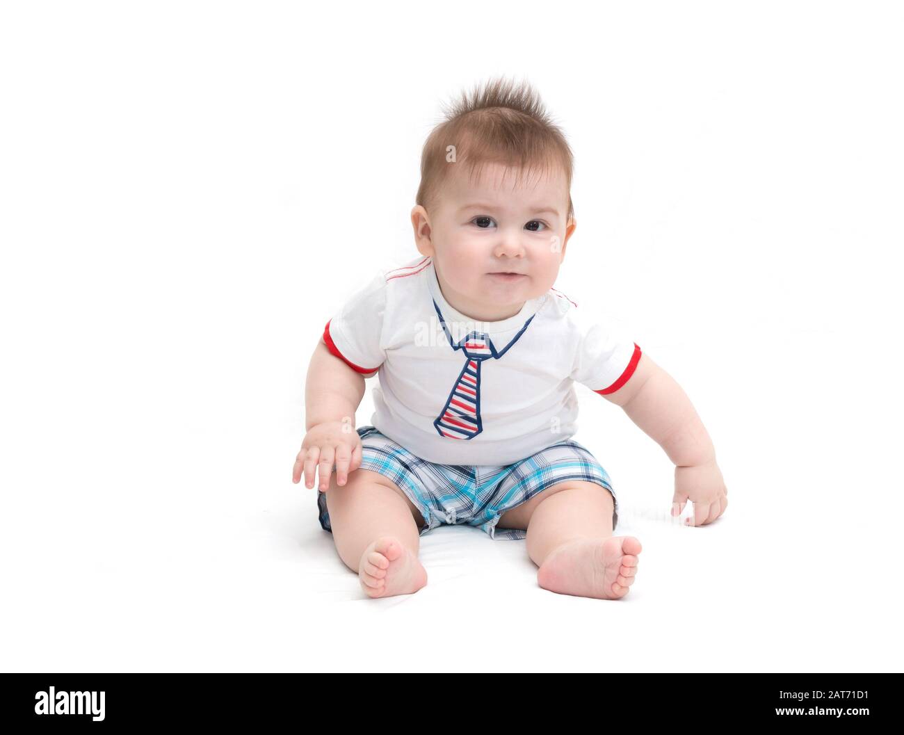 Little smiling baby sitting isolated on white Stock Photo - Alamy