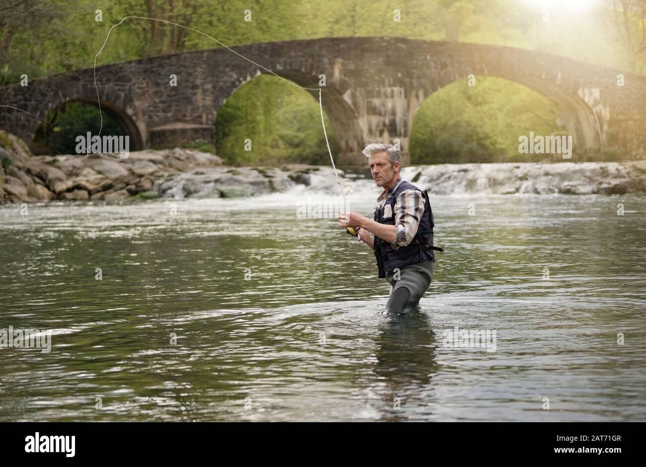 Mature man fly fishing hi-res stock photography and images - Alamy