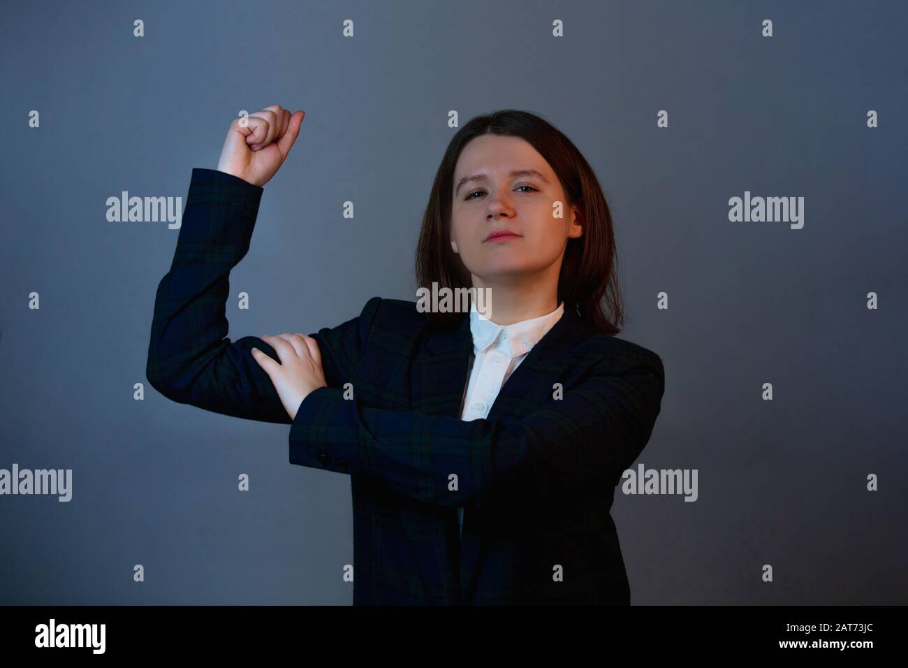 Confident and determined businesswoman flexing muscles showing her ...