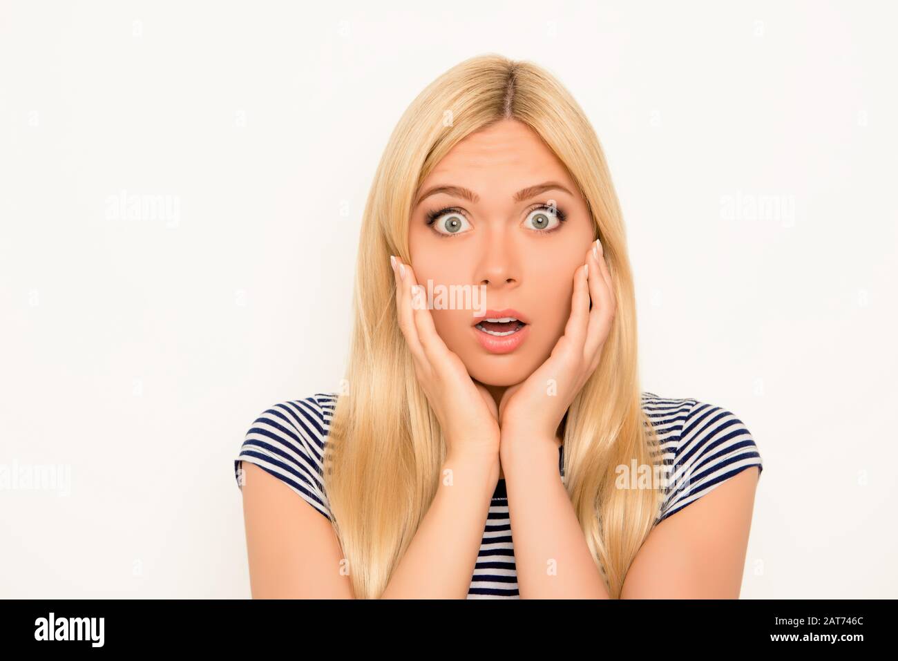 Portrait of sad shocked young woman touching face Stock Photo - Alamy