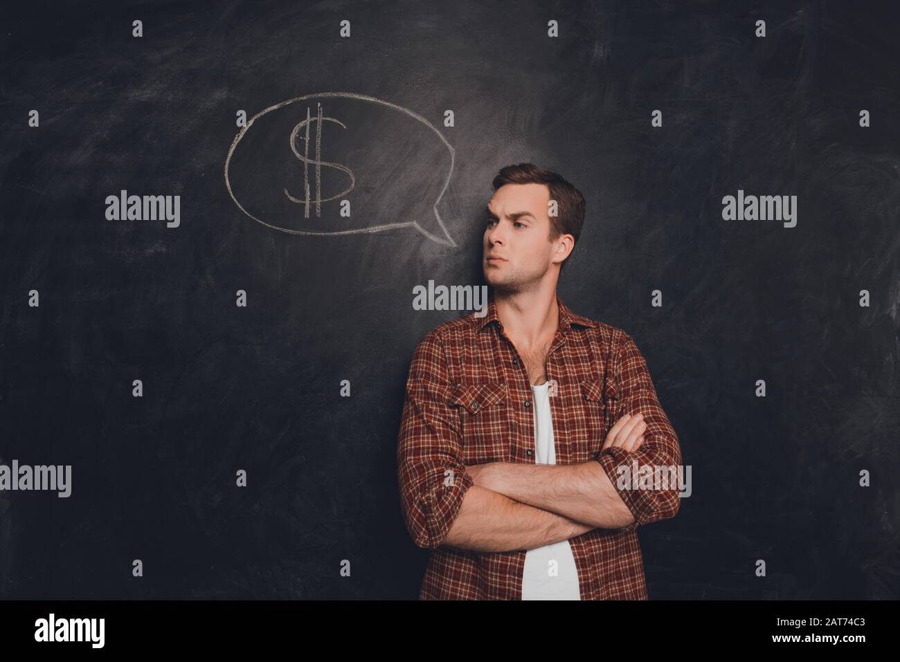Serious businessman with crossed hands thinking how to earn money Stock ...