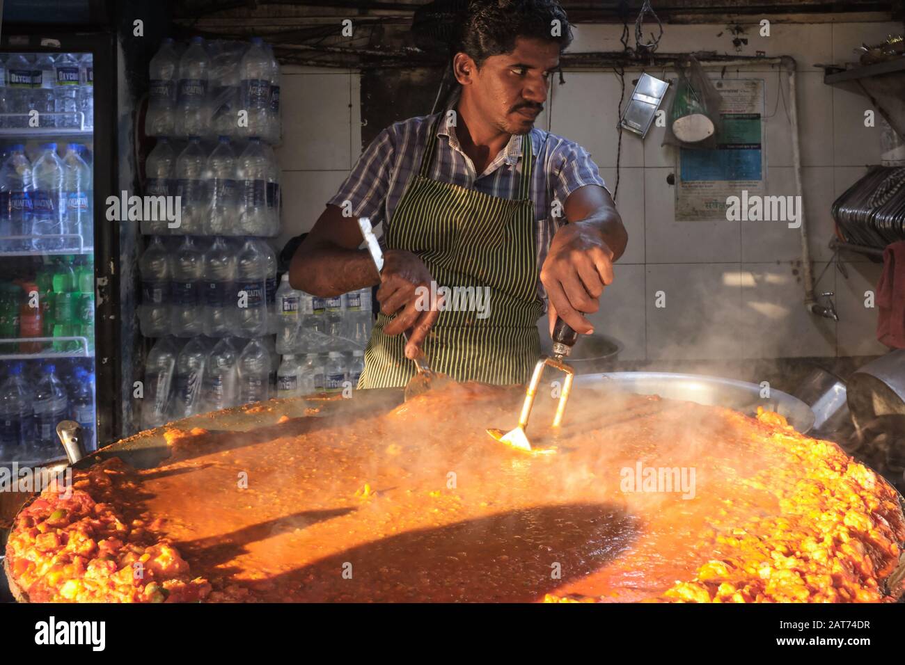 A cook at a food stall in Mumbai, India, makes 'bhaji', a vegetable ...