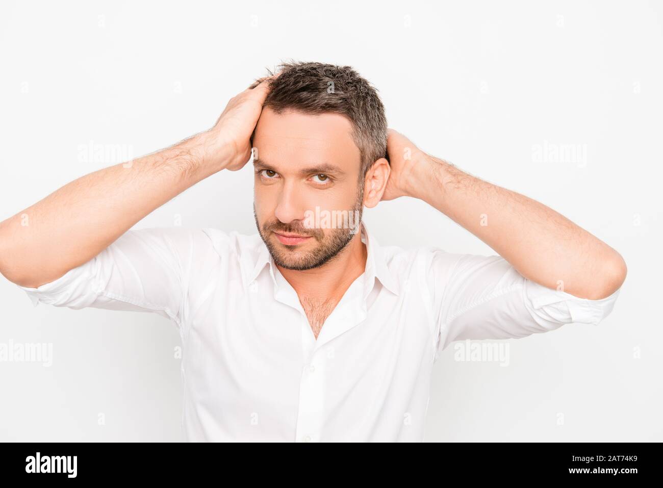 Attractive man touching his hair on white background Stock Photo - Alamy