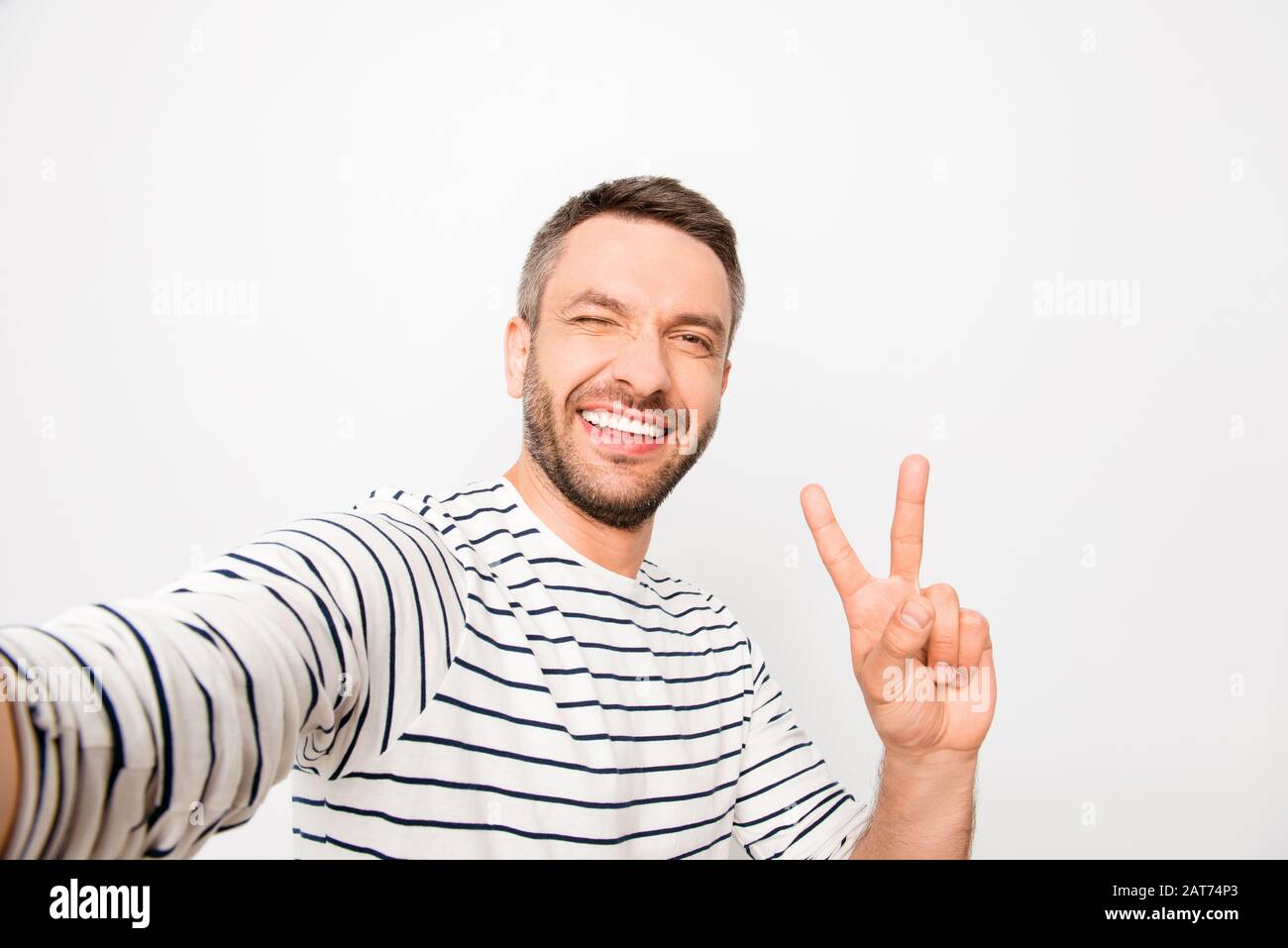 Happy man making selfie and showing two fingers Stock Photo - Alamy