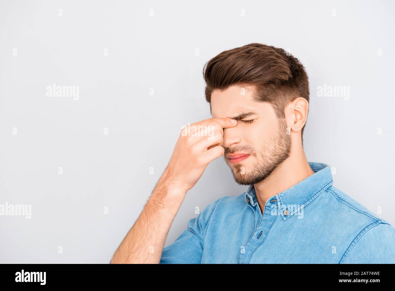 Handsome young overworked man thinking how to solve problems Stock ...