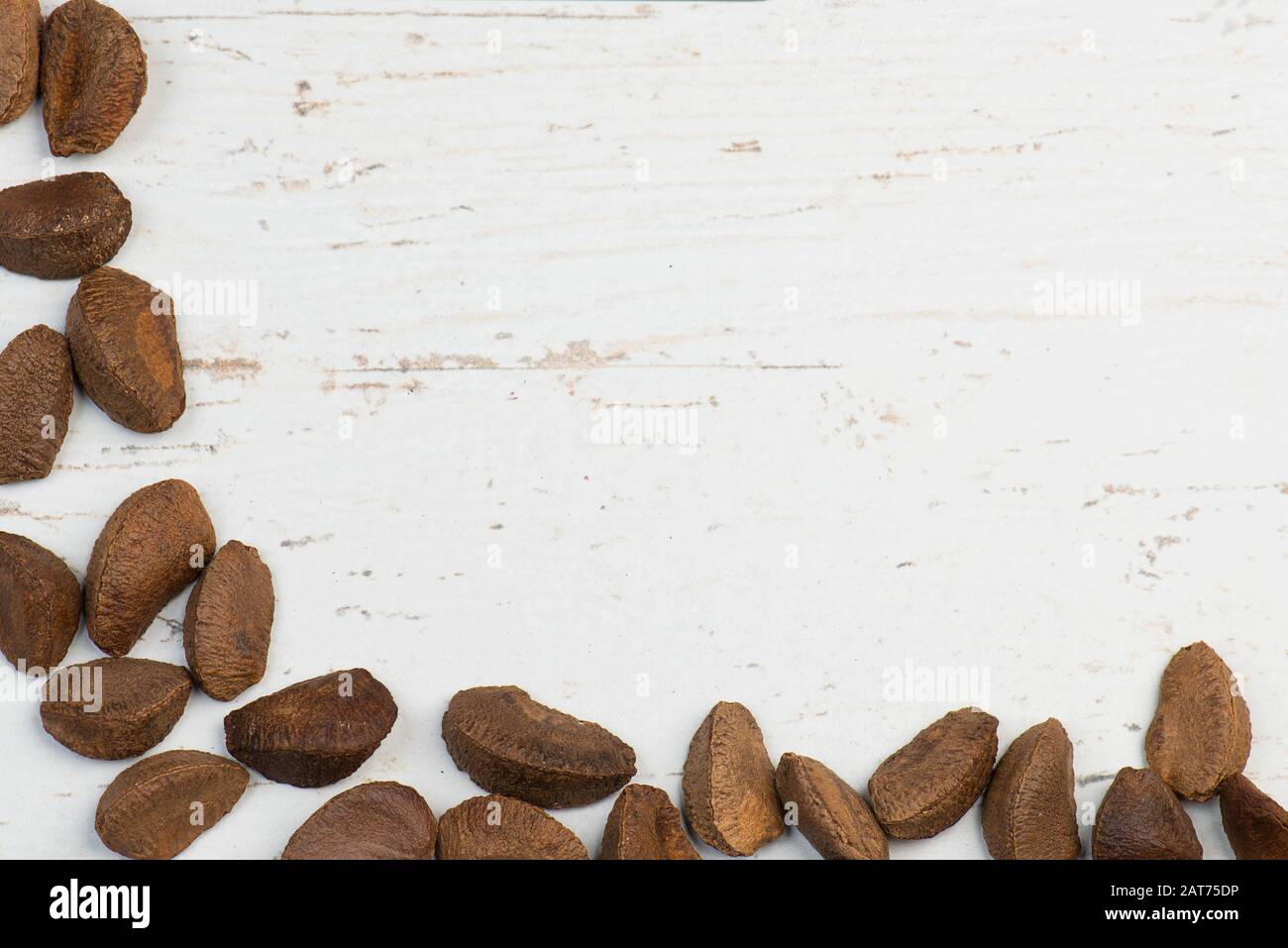 Pecan nuts in the nutshell on a white textured backgropund, empty copy ...