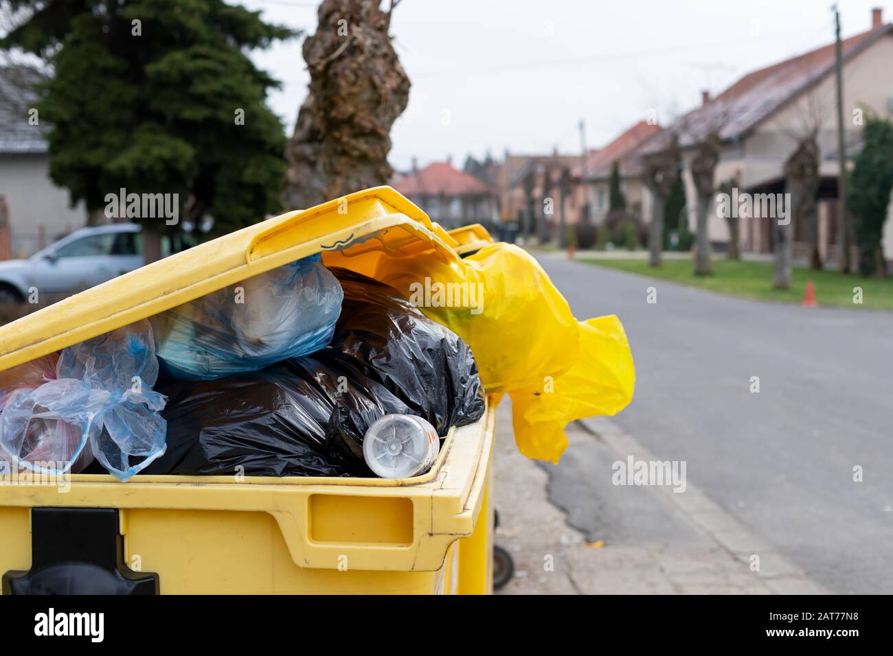 Overfilled trash dumpster full with mixed trash on a street Stock Photo ...