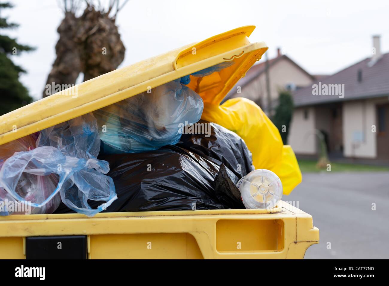 Overfilled trash dumpster full with mixed trash on a street Stock Photo ...