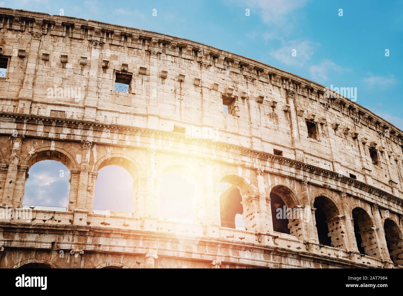 Colosseum or Coliseum ancient ruins background blue sky Rome, Italy ...