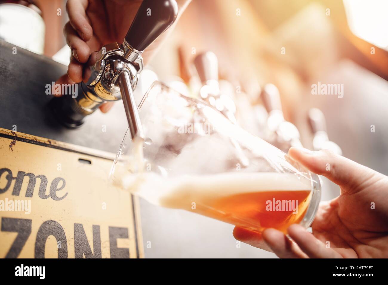 Light Draft cold beer pour in glass from crane in pub Stock Photo - Alamy